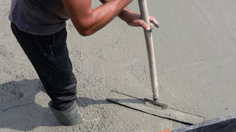 A Worker Compacts Fresh Concrete with Crushed Stone Using a Special ...