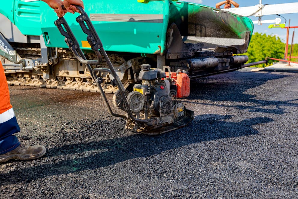 Worker Compacts Tarmac Using Vibration Plate Compactor Stock Photo ...