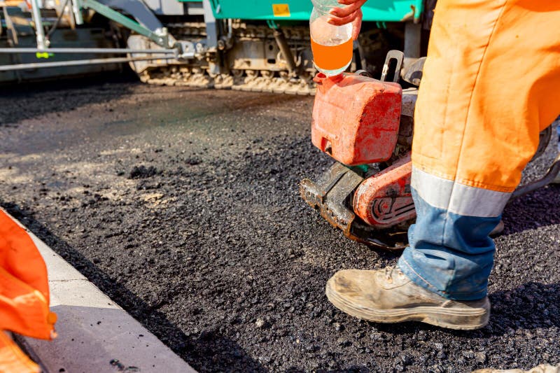 Worker Compacts Tarmac Using Vibration Plate Compactor Stock Photo ...