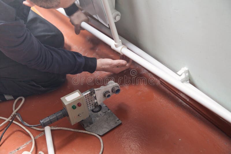 Worker Connecting Plastic Pipe. Installing Water Heating Radiator Stock ...