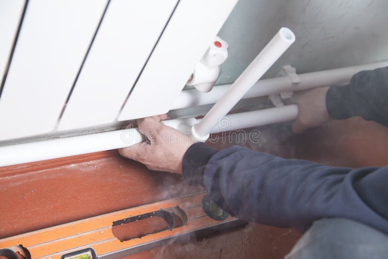 Worker Connecting Plastic Pipe. Installing Water Heating Radiator Stock ...