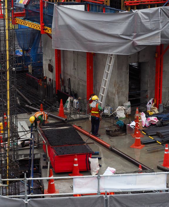 Worker in Construction Area Work in Wet Place after Heavy Rain Stock ...