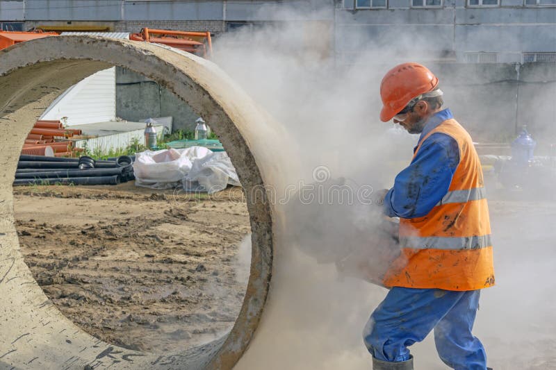 Builder in Orange Uniform with a Concrete Cutter Stock Photo - Image of ...