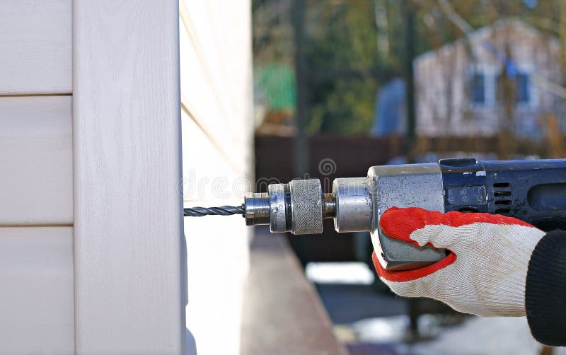 Worker at Construction Site Drills Wall Drilling Machine Stock Photo ...