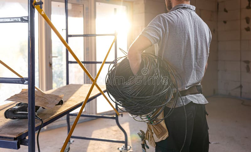 A Worker at a Construction Site Holds an Electrical Cable Stock Image ...