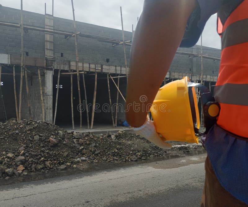 A Worker at Construction Site. he Looking at the Worksite the ...
