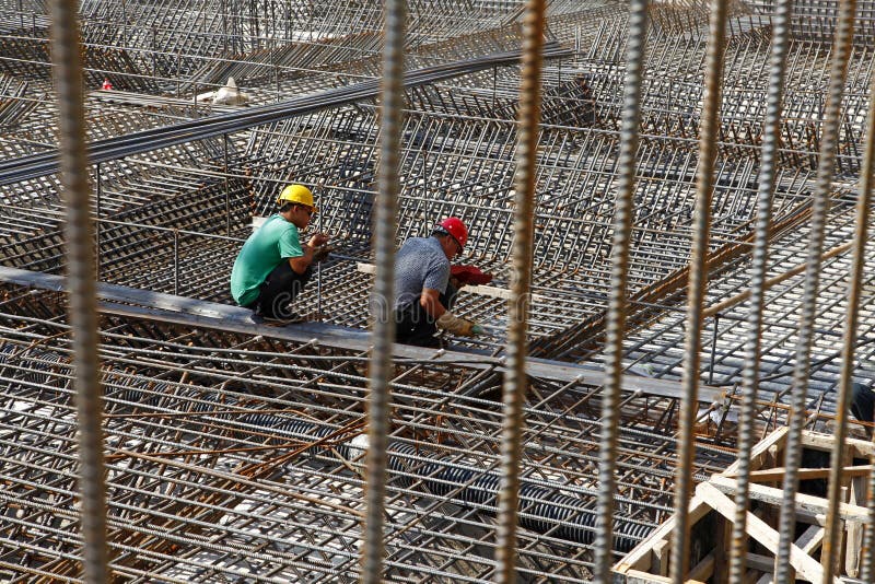 Worker in the Construction Site Making Reinforcement Metal Framework ...