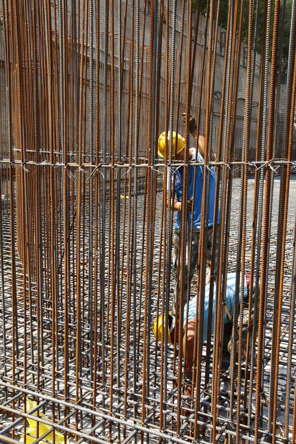 Worker in the Construction Site Making Reinforcement Metal Framework ...