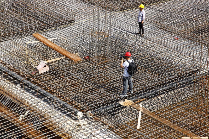 Worker in the Construction Site Making Reinforcement Metal Framework ...