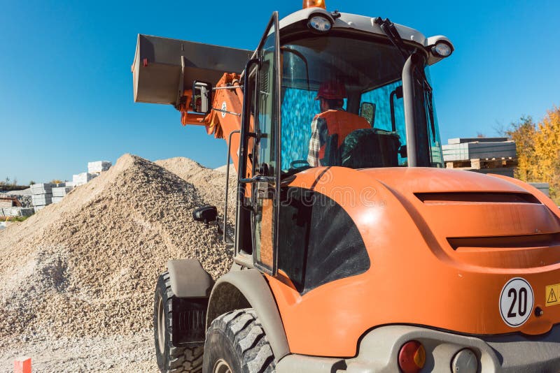 Worker on Construction Site Operating Wheel Loader Stock Image - Image ...