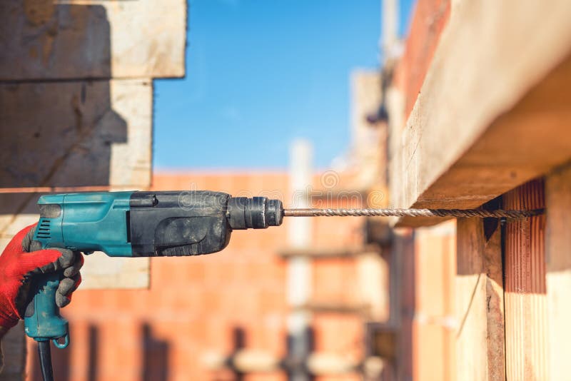 Worker on Construction Site Using Drilling Machine and Wire Rod Stock ...