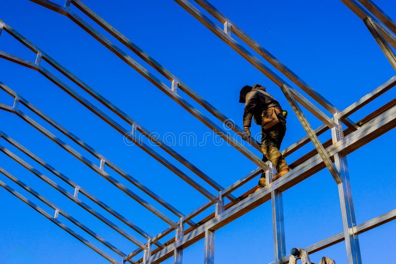 Worker Constructs Framework of Building Under Clear Blue Sky during ...