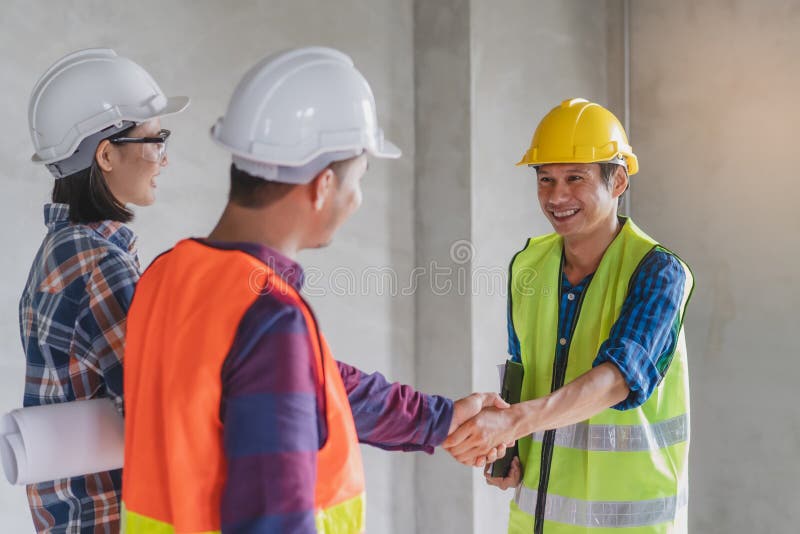 Worker and Contractor. Client Shaking Hands with Team Builder in ... Worker and Contractor. Client Shaking Hands with Team Builder in ...
