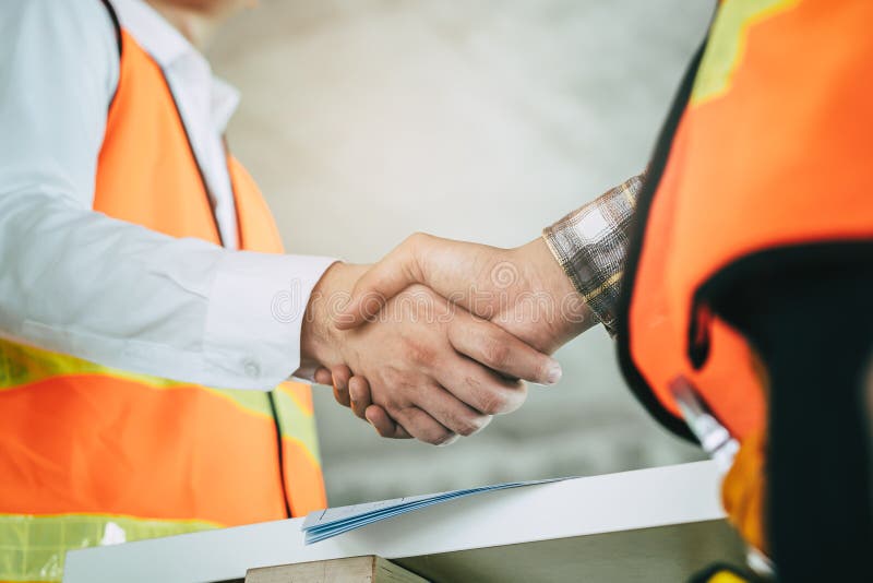 Worker and Contractor. Client Shaking Hands with Team Builder in ... Worker and Contractor. Client Shaking Hands with Team Builder in ...