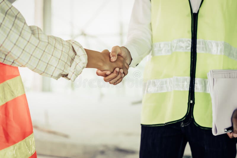 Worker and Contractor. Client Shaking Hands with Team Builder in ... Worker and Contractor. Client Shaking Hands with Team Builder in ...