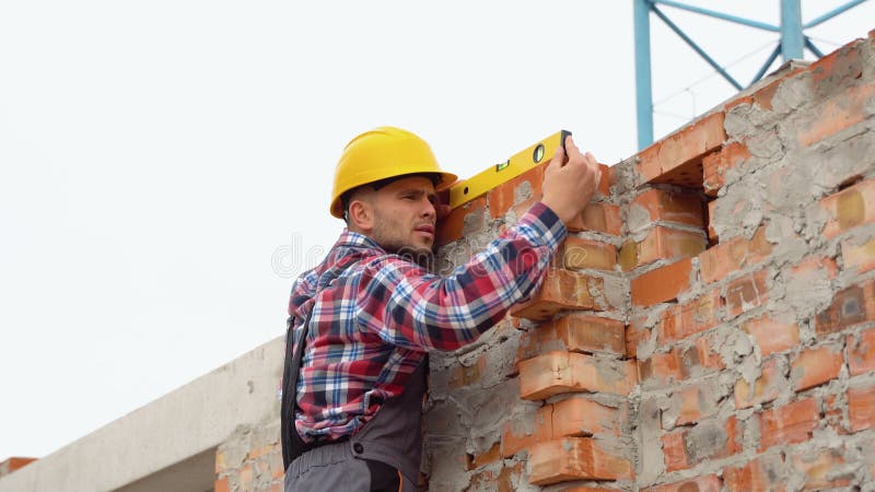 Worker Control Brick Wall Using Level Tool. Real Estate Project with ...