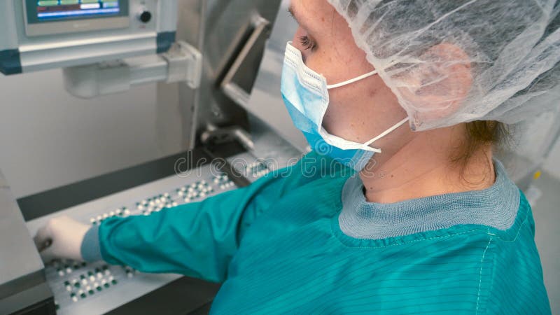 Worker Control the Process of Sorting Capsules into Packages at ...