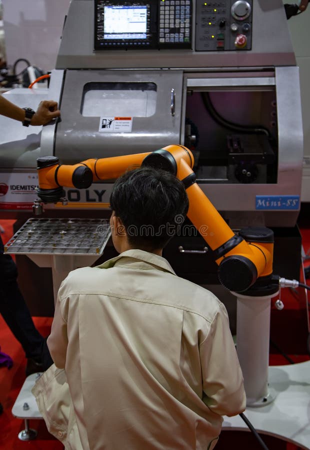 Worker Control Robot Arm To Loading and Unloading Workpiece Editorial ... Worker Control Robot Arm To Loading and Unloading Workpiece Editorial ...