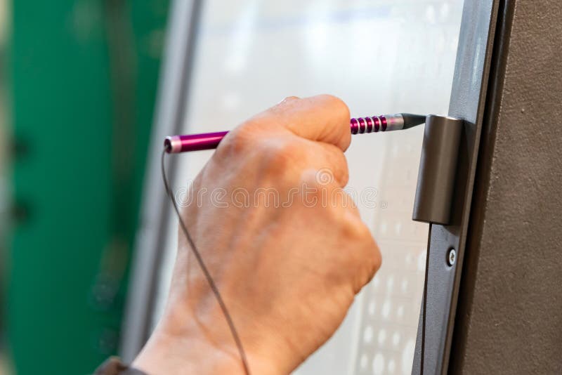 A Worker Controls the Machine by Typing a Program on the Remote Control ...