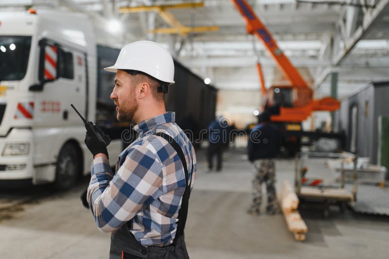 A Worker Controls the Process of Loading a Modular House Onto a Truck ...