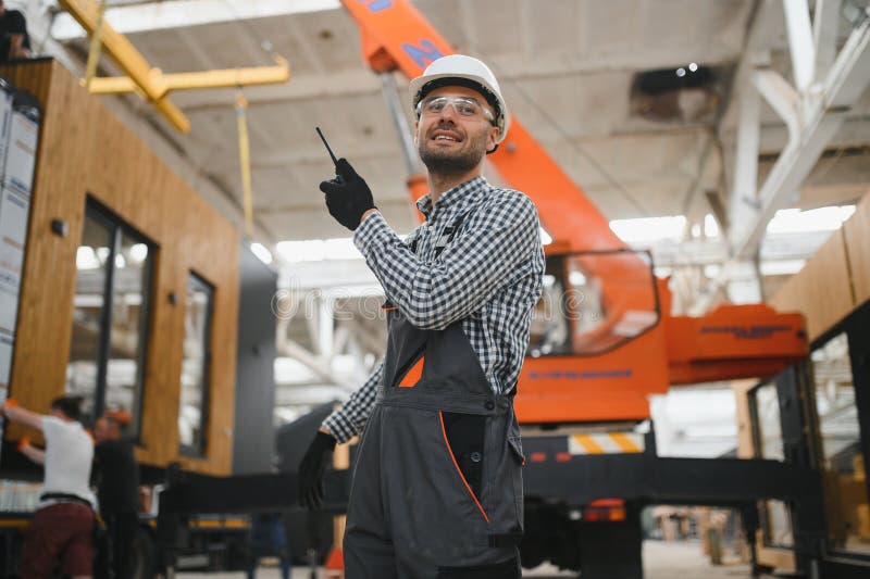 A Worker Controls the Process of Loading a Modular House Onto a Truck ...