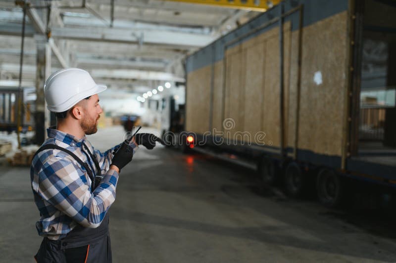 A Worker Controls the Process of Loading a Modular House Onto a Truck ...