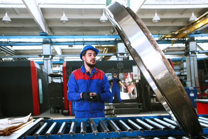 A Worker Controls the Transportation of a Large Diameter Bearing. the ...
