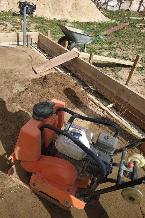 The Worker Controls the Vibrating Plate at the Construction Site, Heavy ...