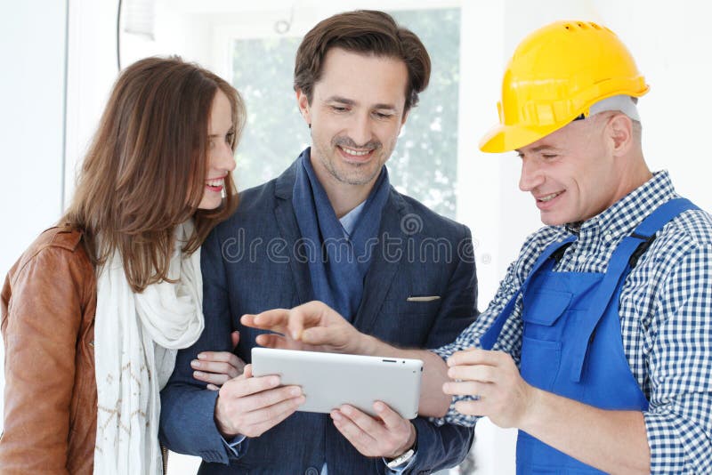 Worker and Couple at Construction Site Stock Photo - Image of home ...