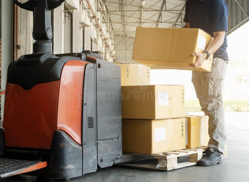 Worker Courier Lifting Shipments Boxes at the Warehouse. Stock Photo ...