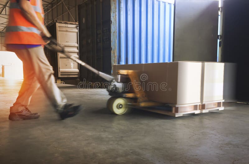 Worker Courier Using Hand Pallet Jack Unloading Package Boxes into ...
