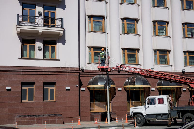 Worker in a Cradle Inspecting Facade of Building Stock Photo - Image of ...
