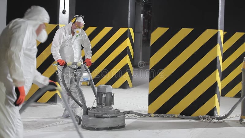 A Worker Creates a Level Concrete Floor. Concrete Floor Grinding ...
