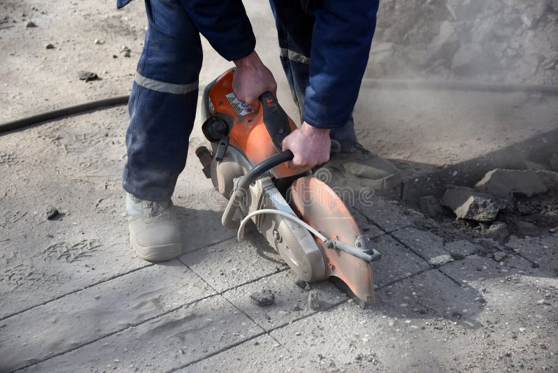 A Worker Cuts Asphalt, Saws the Road Surface. Stock Image - Image of ...