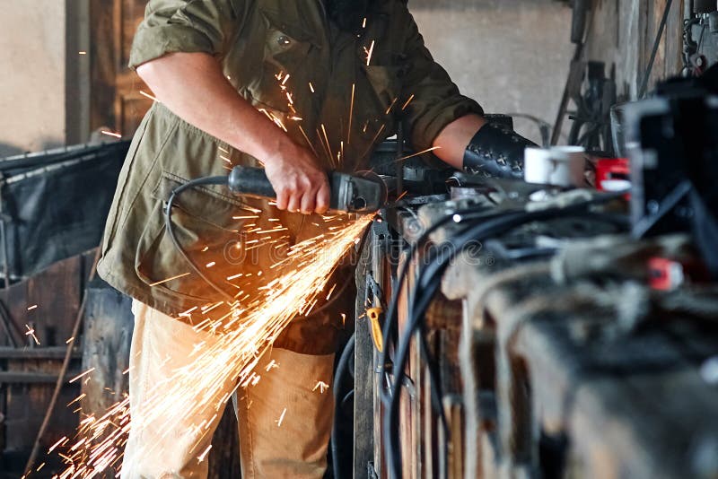 Worker Cuts Detail Angle Grinder in the Workshop and Throws Sparks ...
