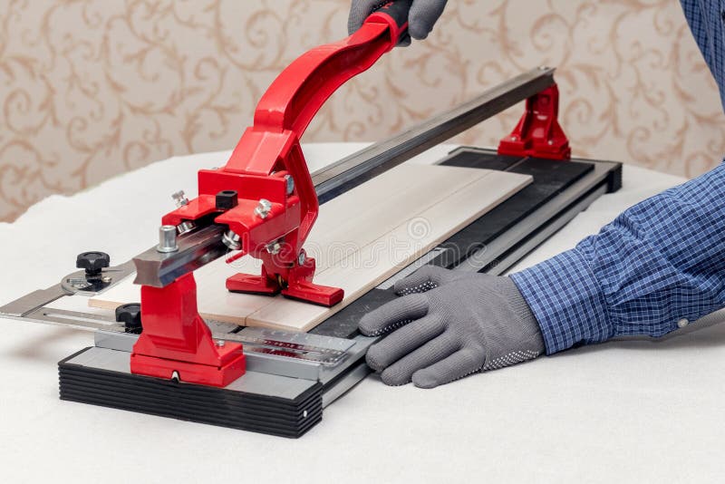 A Worker Cuts Facing Tiles with a Tile Cutter Stock Image - Image of ...
