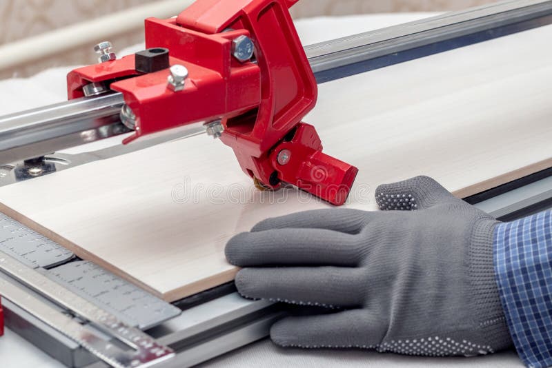 A Worker Cuts Facing Tiles with a Tile Cutter Stock Image - Image of ...