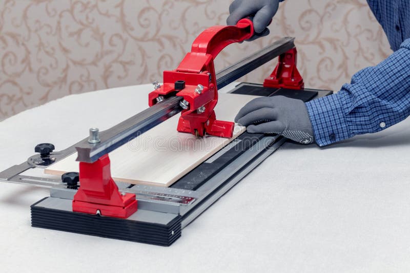 A Worker Cuts Facing Tiles with a Tile Cutter Stock Image - Image of ...