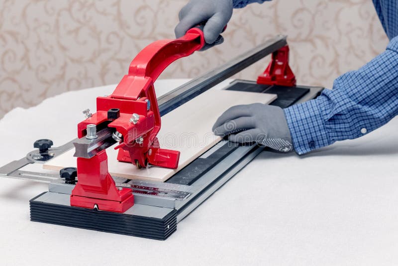 A Worker Cuts Facing Tiles with a Tile Cutter Stock Photo - Image of ...