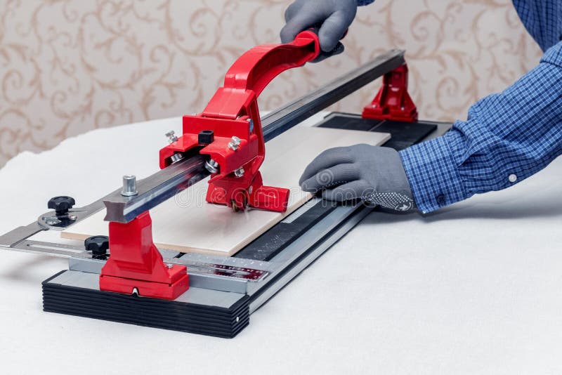 A Worker Cuts Facing Tiles with a Tile Cutter Stock Photo - Image of ...