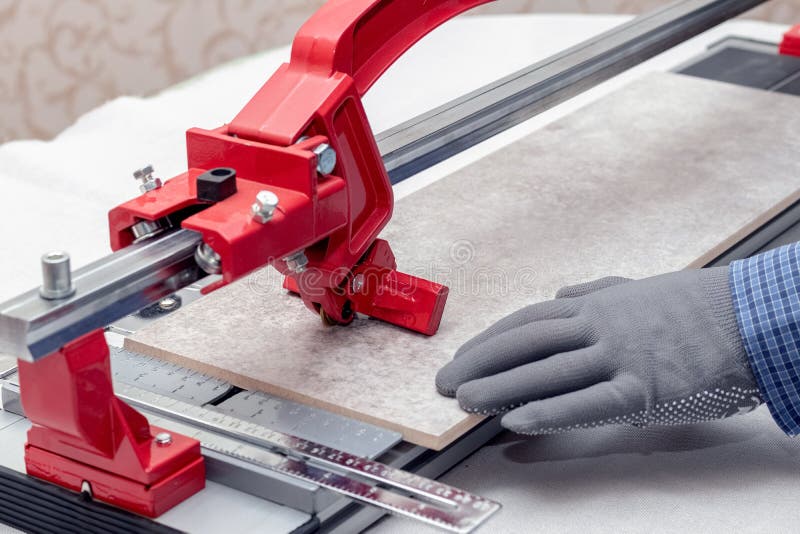 A Worker Cuts Facing Tiles with a Tile Cutter Stock Image - Image of ...