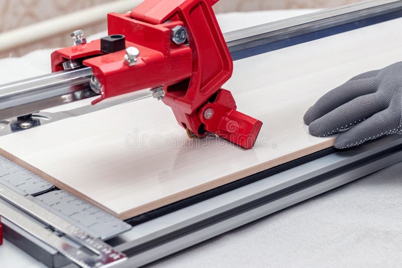 A Worker Cuts Facing Tiles with a Tile Cutter Stock Image - Image of ...