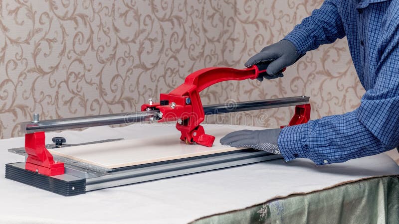 A Worker Cuts Facing Tiles with a Tile Cutter Stock Photo - Image of ...