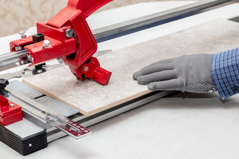 A Worker Cuts Facing Tiles with a Tile Cutter Stock Photo - Image of ...