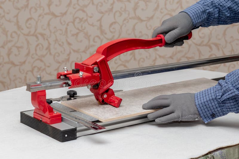 A Worker Cuts Facing Tiles with a Tile Cutter Stock Image - Image of ...