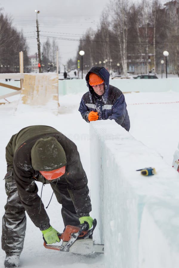 Worker Cuts a Lump of Ice with a Chainsaw Stock Image - Image of ...