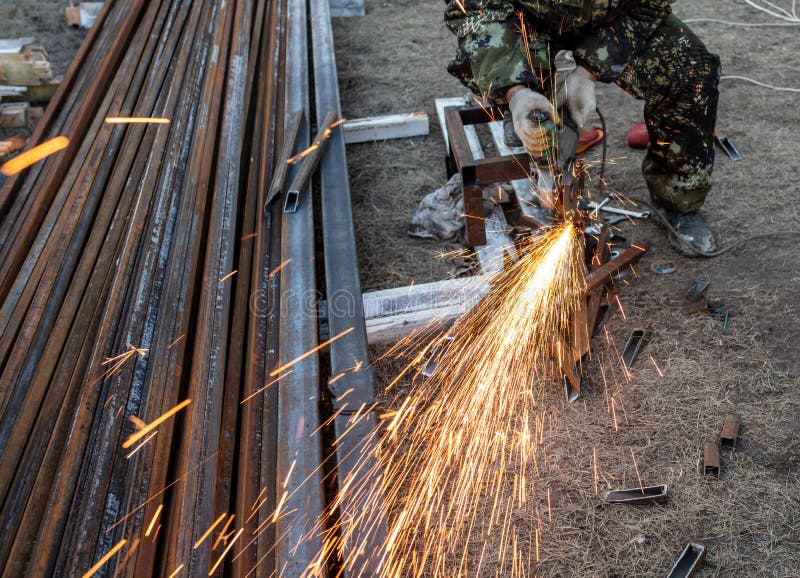A Worker Cuts Metal at a Construction Site. Technology Stock Image ...