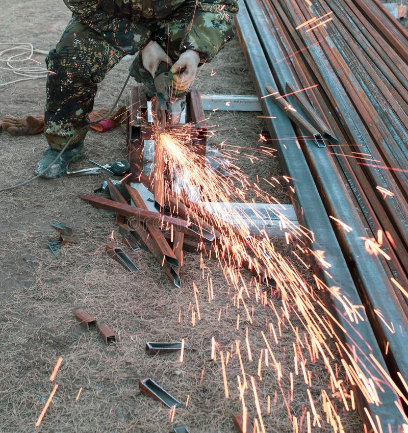 A Worker Cuts Metal at a Construction Site. Technology Stock Photo ...