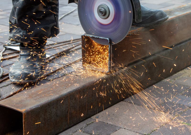 A Worker Cuts Metal at a Construction Site. Stock Image - Image of ...