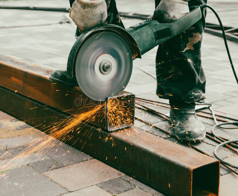 A Worker Cuts Metal at a Construction Site. Stock Photo - Image of work ...